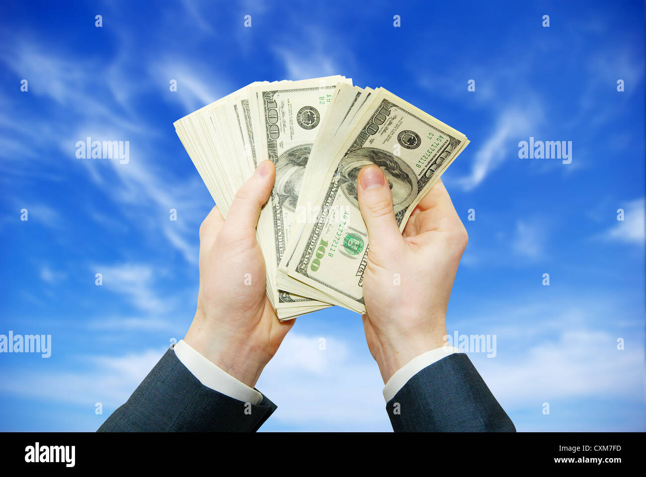 Hand with money isolated on sky background sky Stock Photo - Alamy