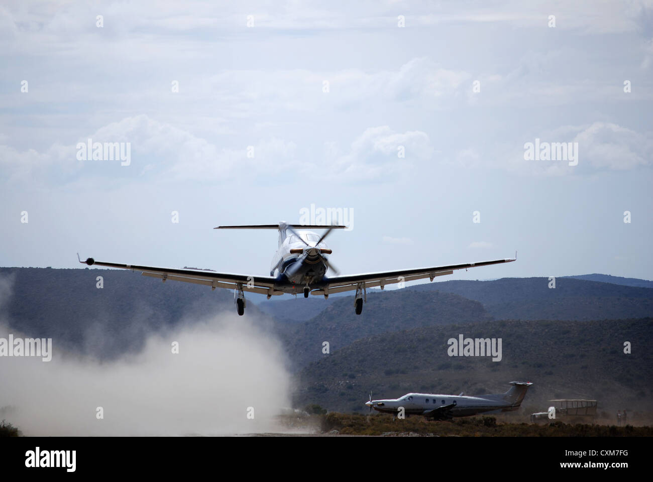 Pilatus Propeller Aircaraft taking Off from Gravel Runway Stock Photo ...