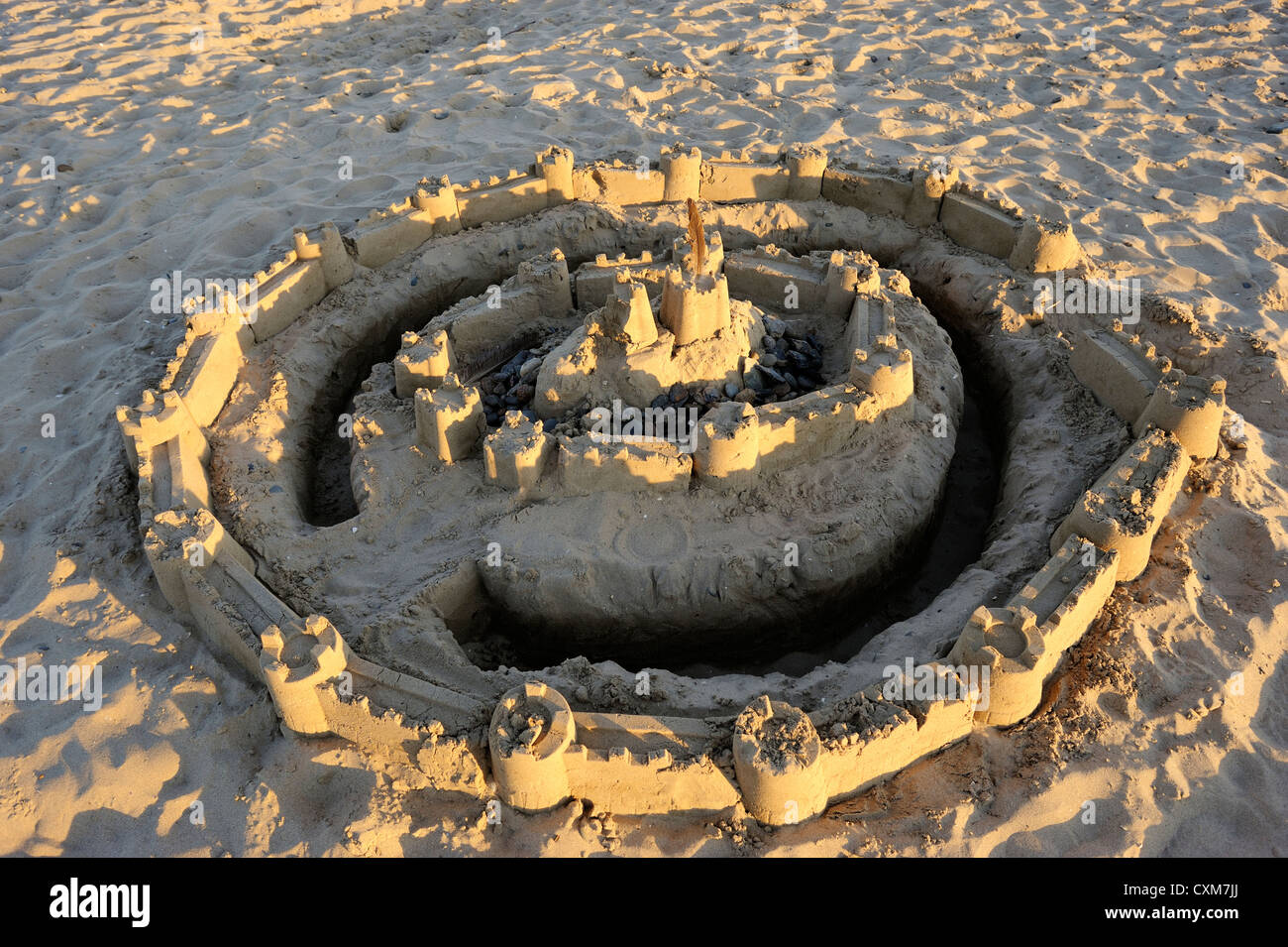 Sand fort on a sunlit beach Stock Photo - Alamy