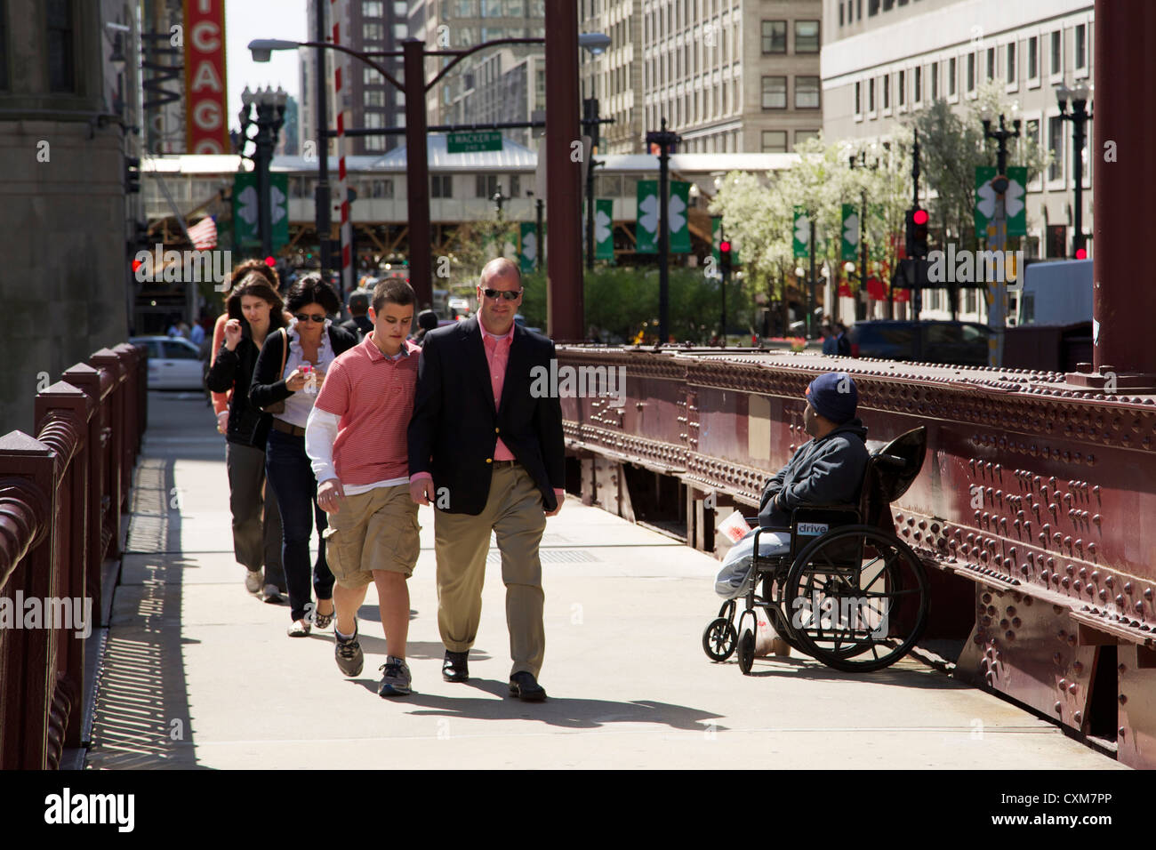 Disabled homeless man and pedestrians on State Street Bridge Chicago ...