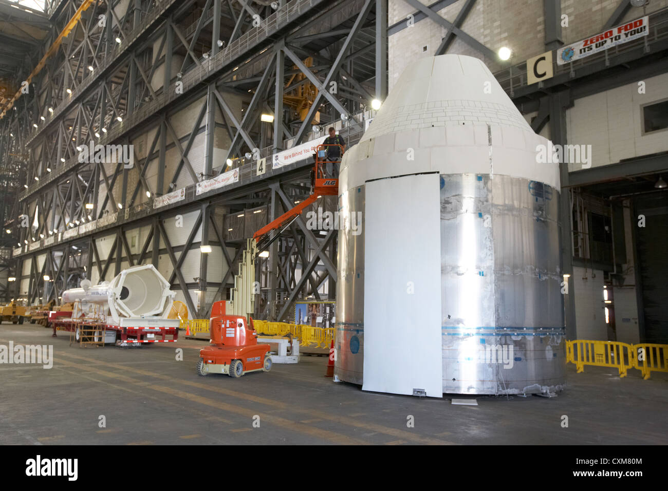 worker works on mockup of the nasa orion command and service modules ...