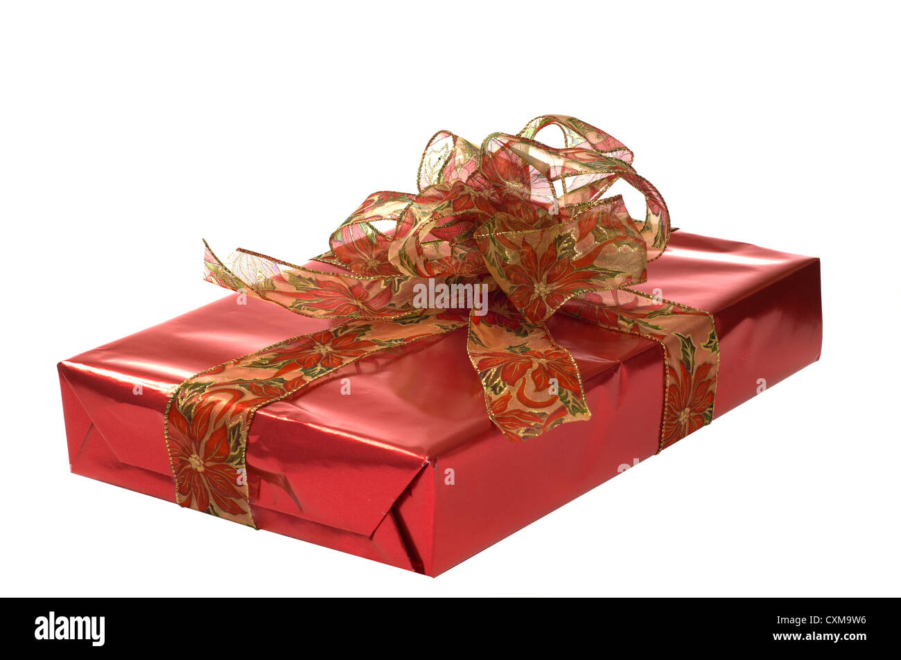A Christmas gift in red wrapping paper with a big bow on white ...