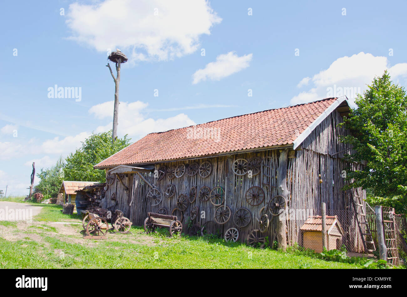 old barn in farm with carriage wheel collection Stock Photo - Alamy