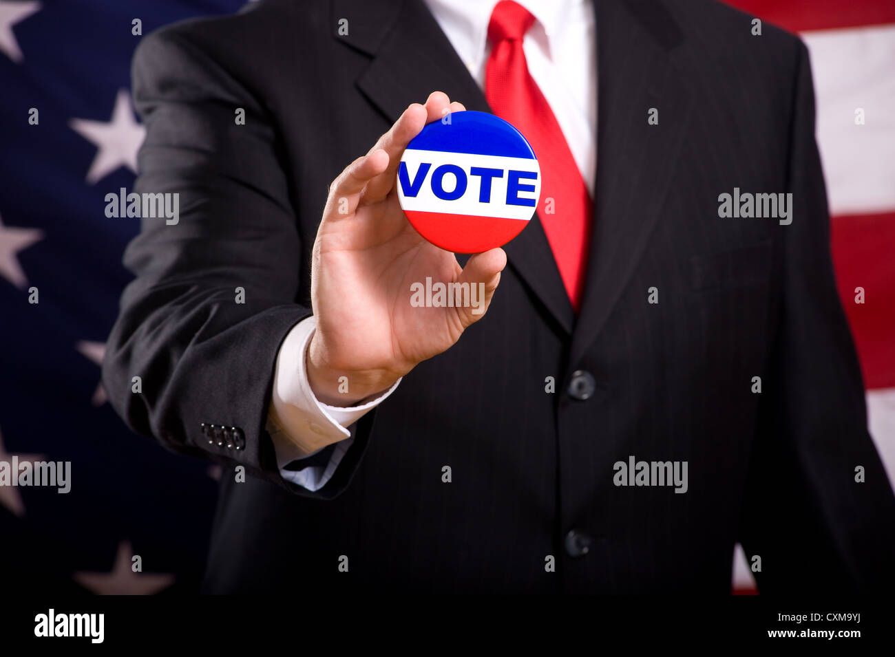 A man wearing a blue business suit and tie with a vote button. Election ...