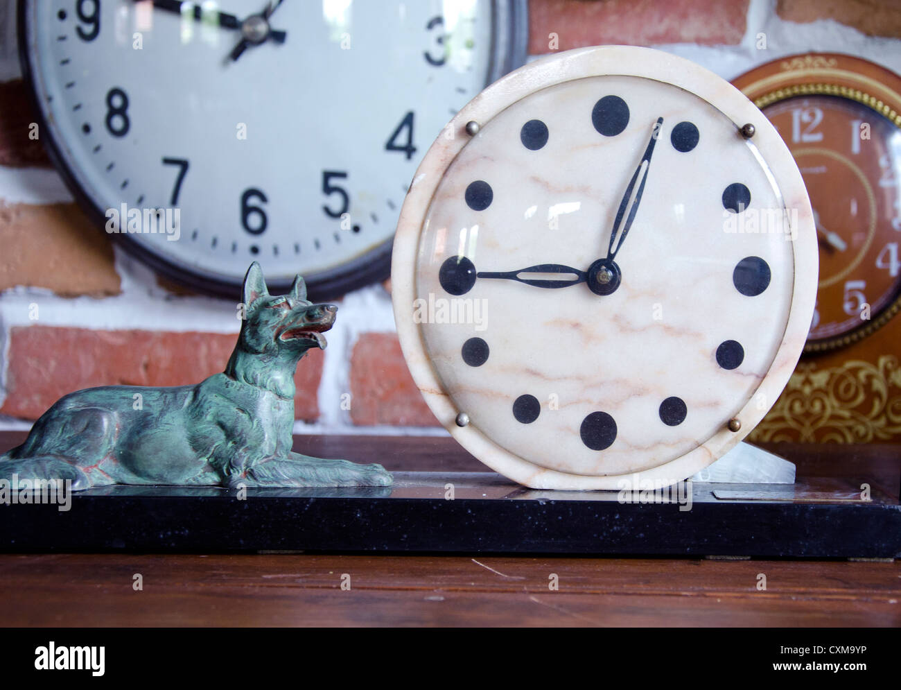 old clock stone dial with brass dog sculpture Stock Photo - Alamy