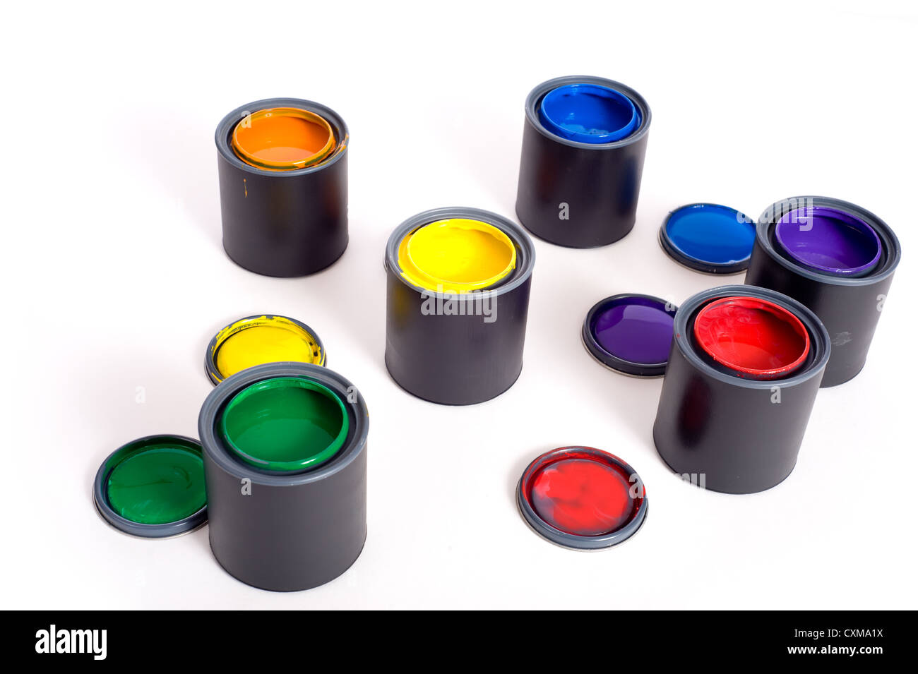 Colorful cans of paint on a white background forming a colorful ...