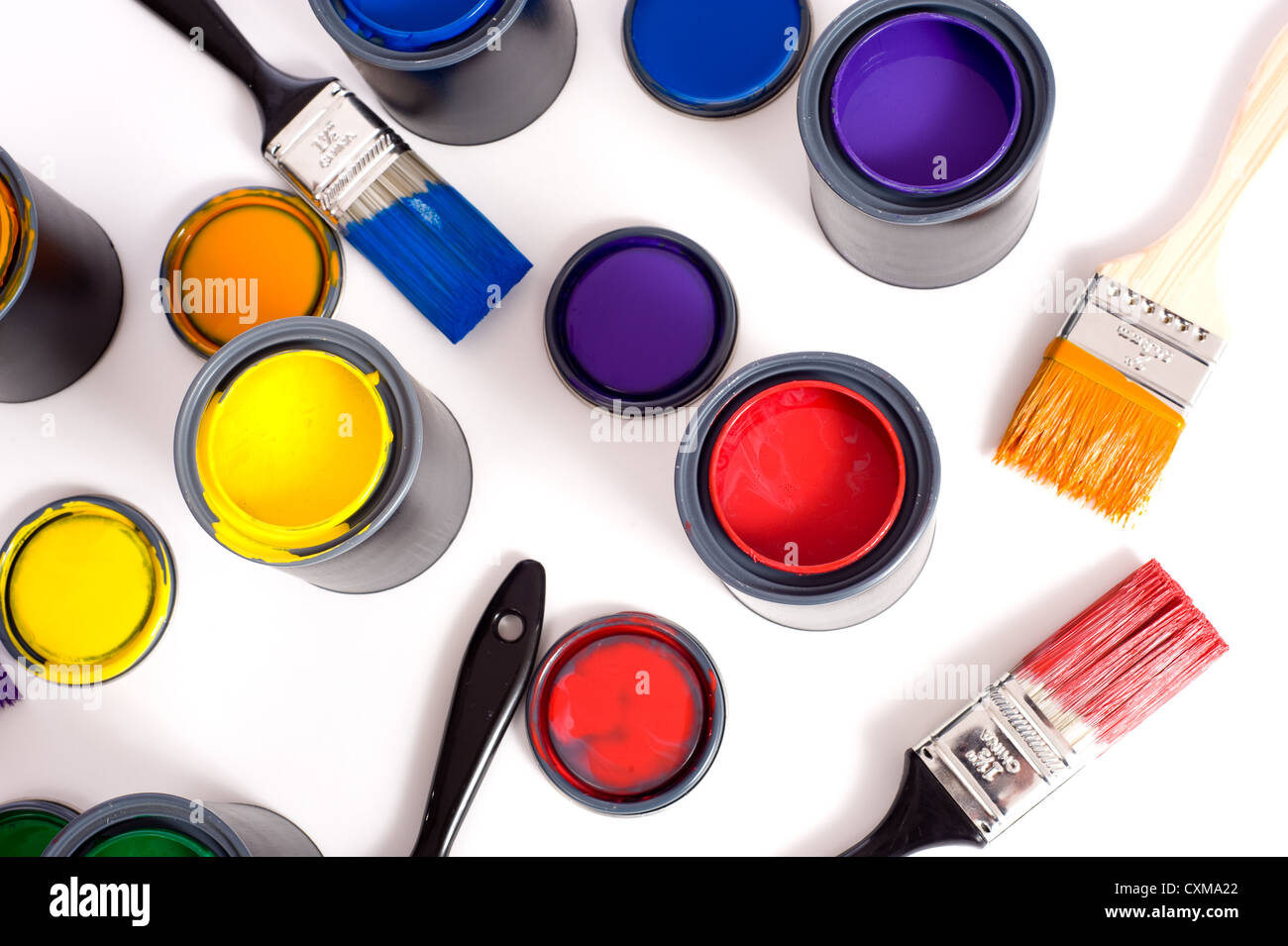 Colorful cans of paint on a white background forming a colorful ...