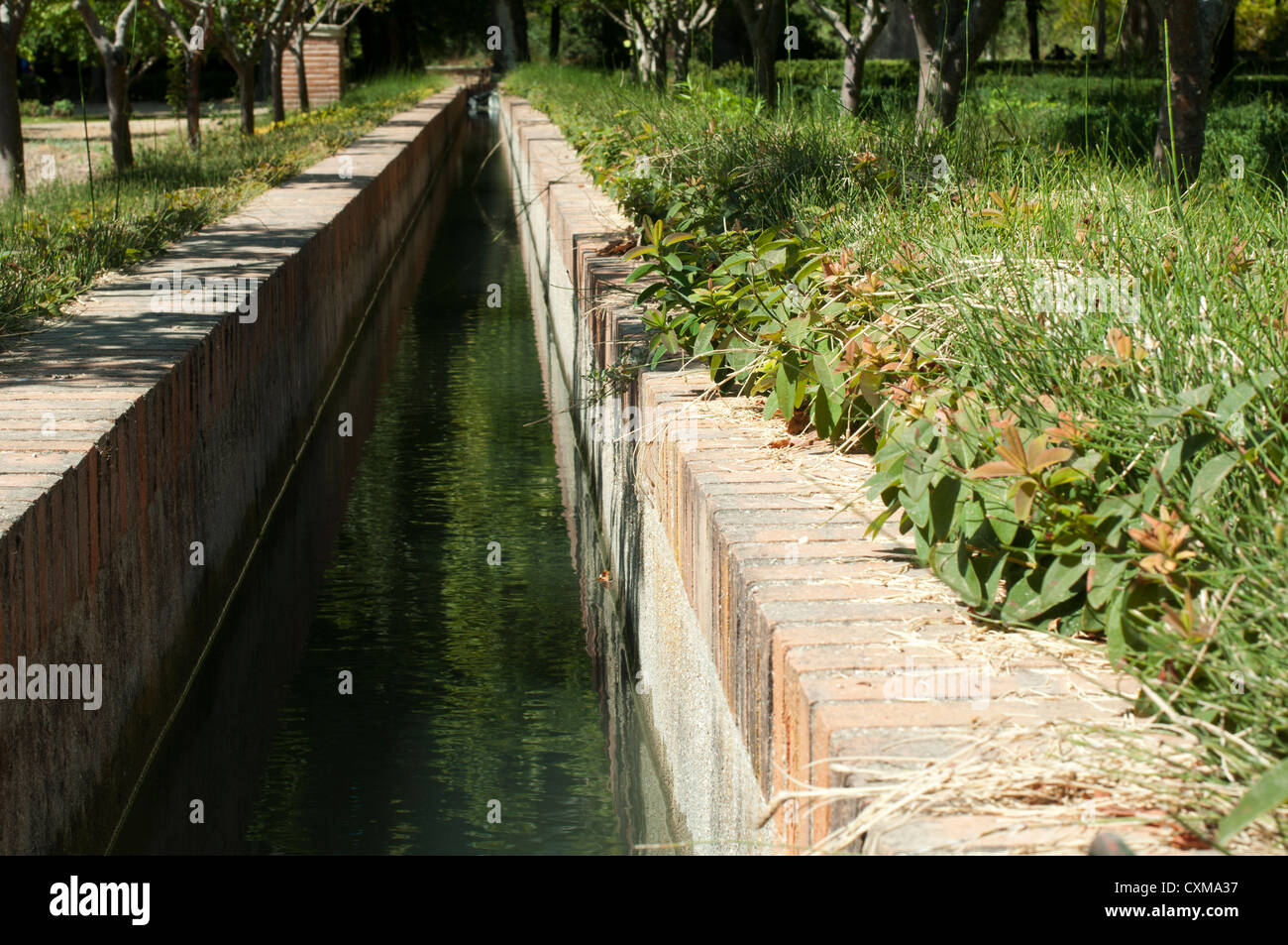 Irrigation canal into the garden Stock Photo - Alamy