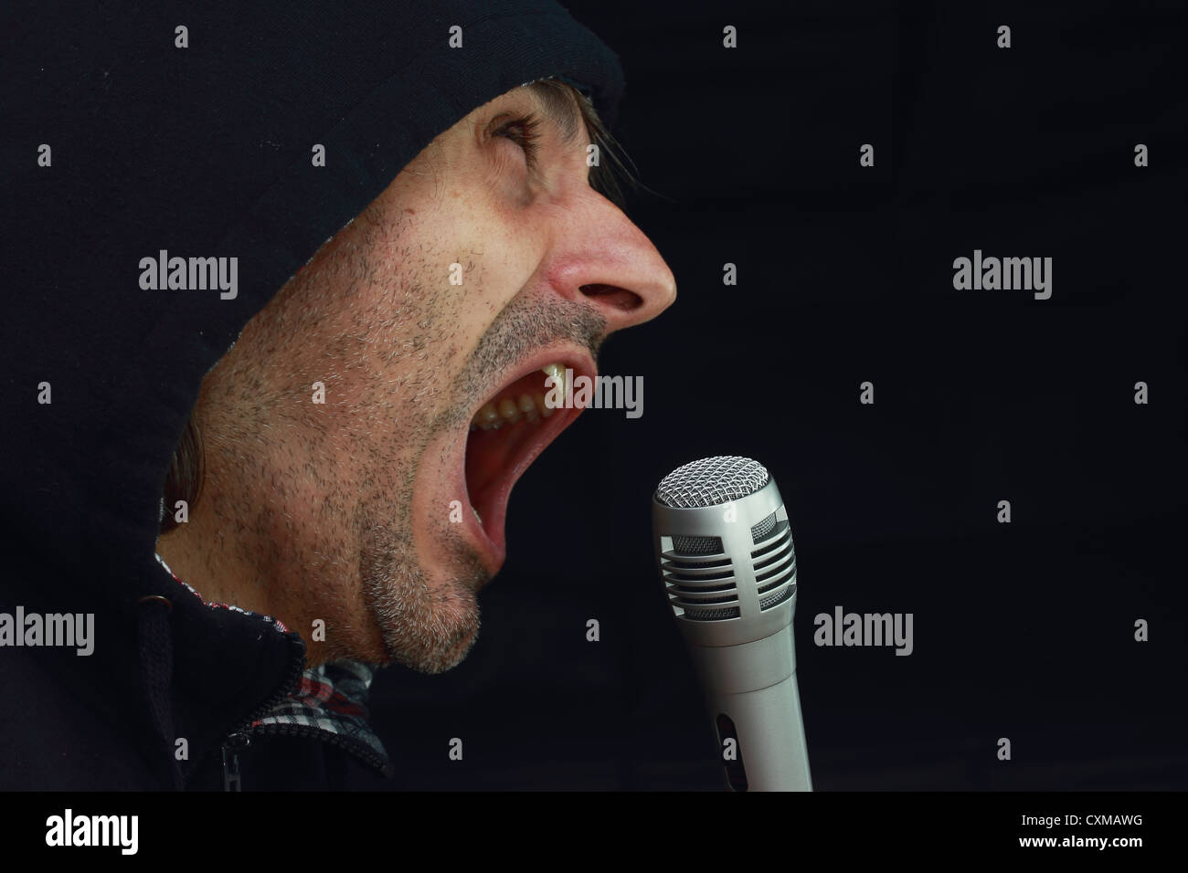 Rockstar singing over black background Stock Photo - Alamy
