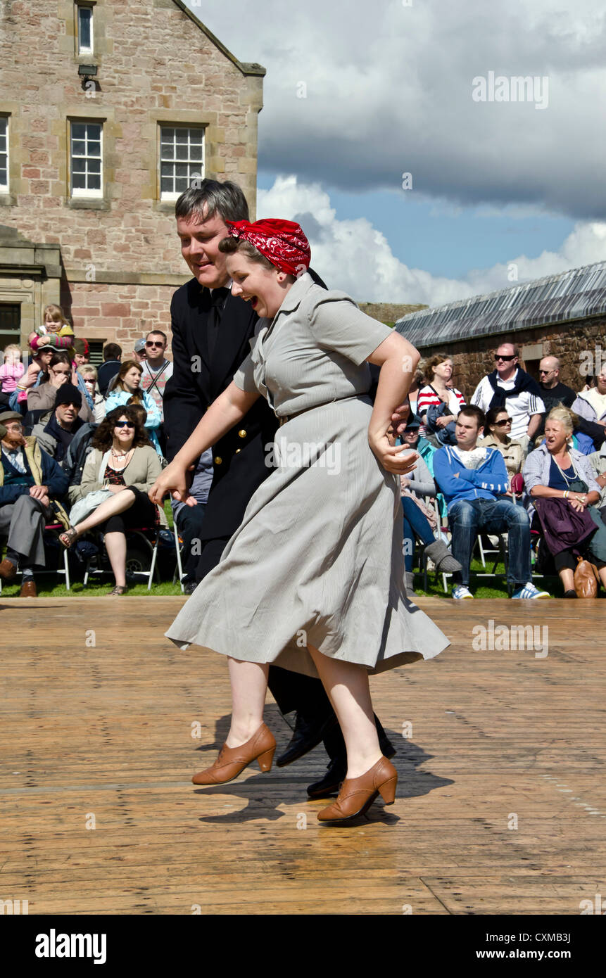 Couple in WW2 period clothes dancing the jitterbug at an historic event ...