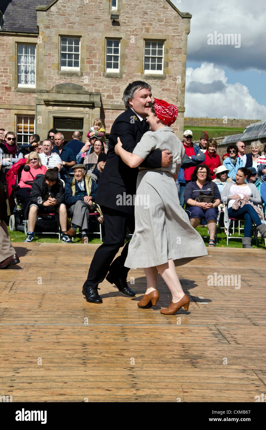 Couple in WW2 period clothes dancing the jitterbug at an historic event ...