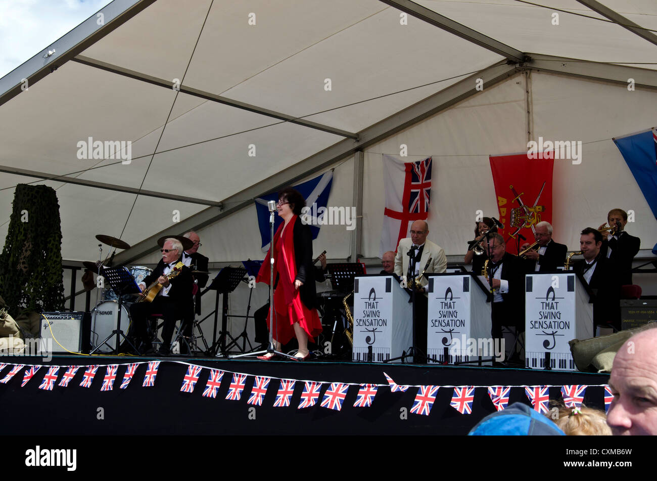 Band playing for couple in WW2 period clothes dancing the jitterbug at ...