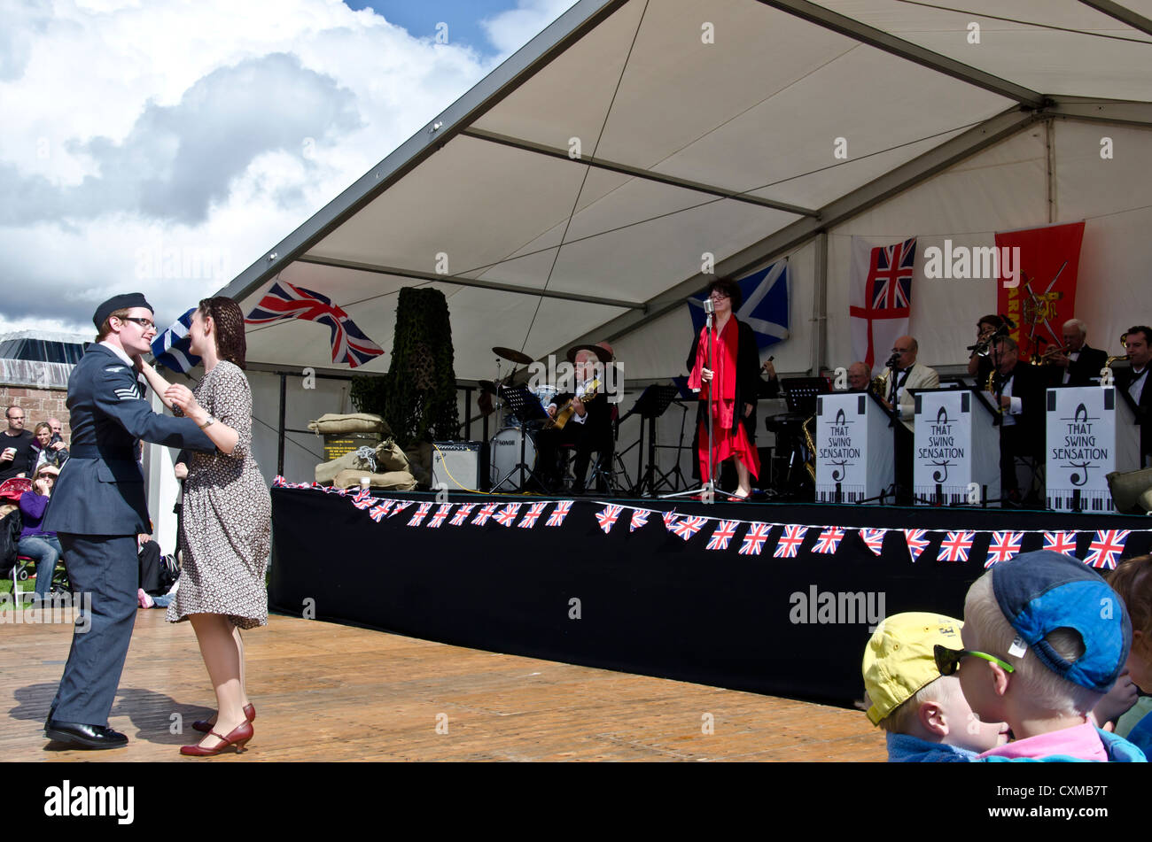 Couple in WW2 period clothes dancing the jitterbug at an historic event ...
