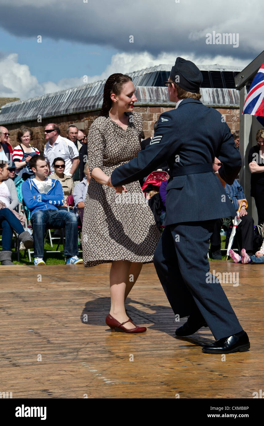 Couple in WW2 period clothes dancing the jitterbug at an historic event ...