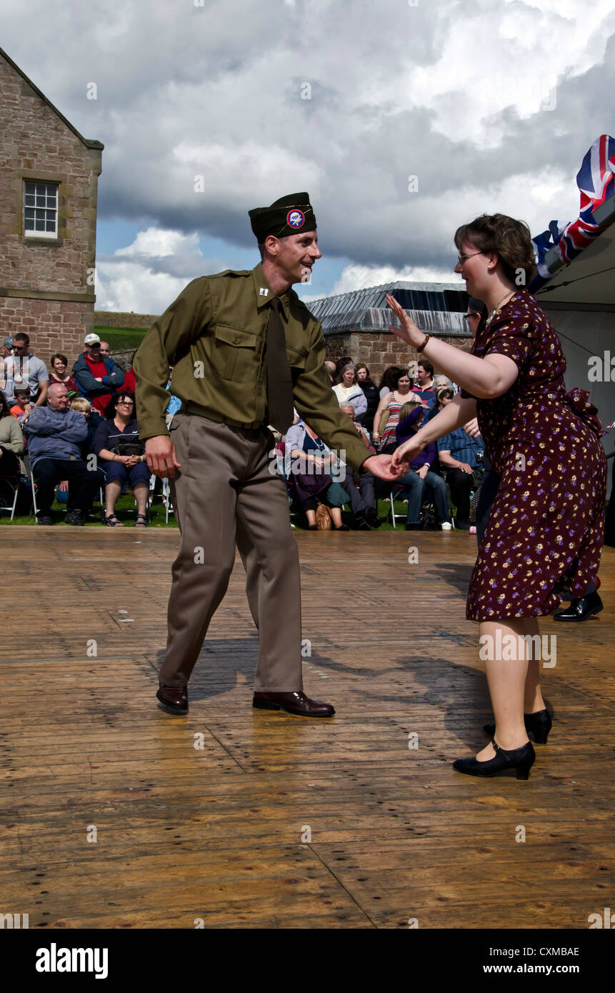 Couple in WW2 period clothes dancing the jitterbug at an historic event ...