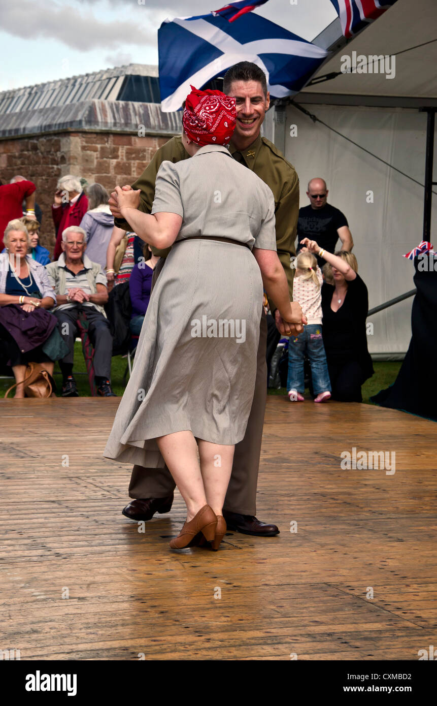 Couple in WW2 period clothes dancing the jitterbug at an historic event ...