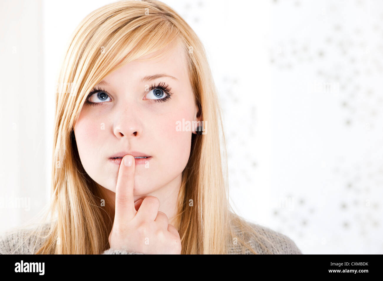 Young woman is thinking Stock Photo - Alamy