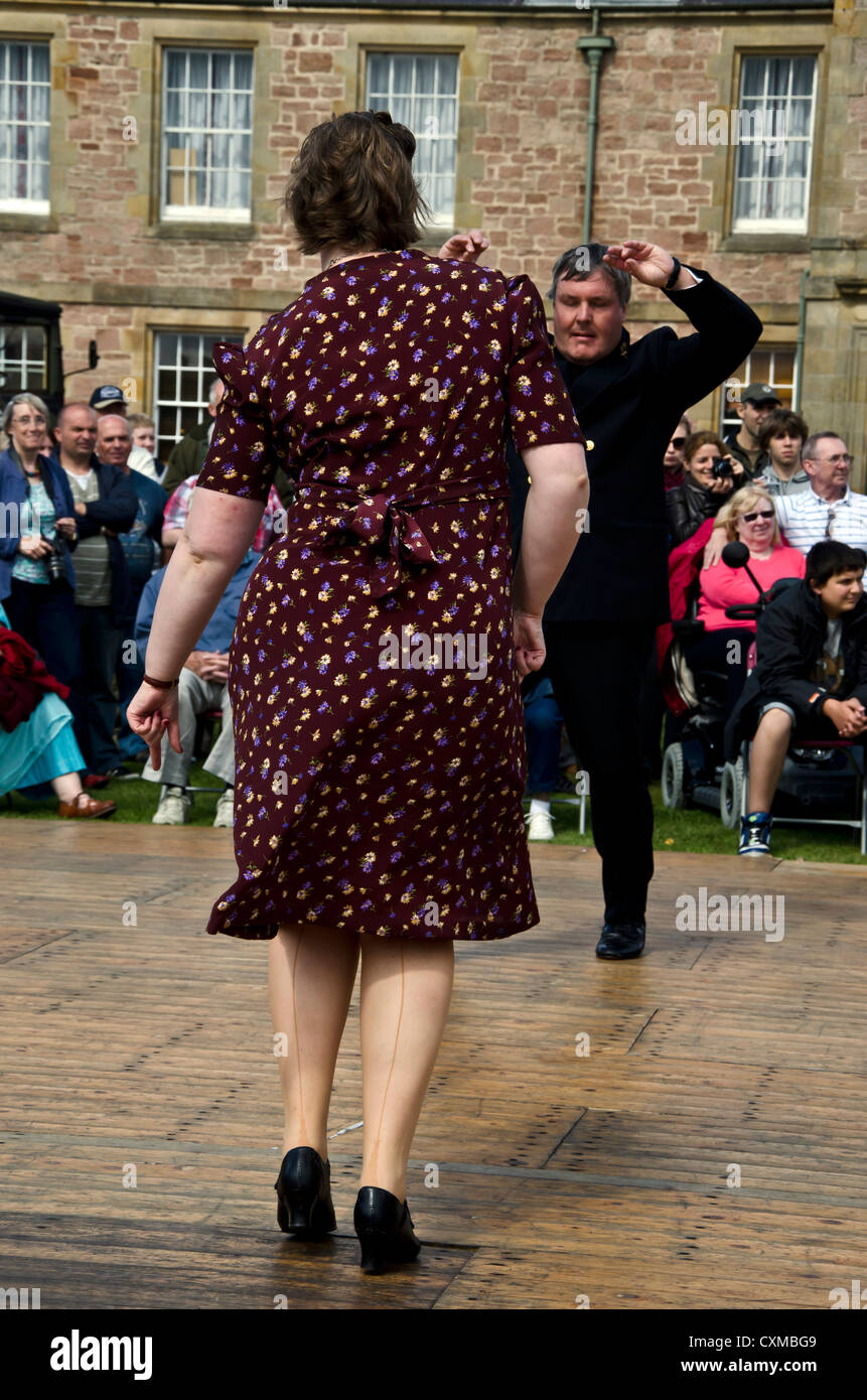 Couple in WW2 period clothes dancing the jitterbug at an historic event ...