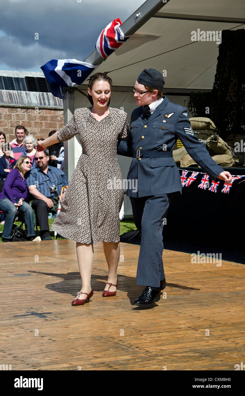 Couple in WW2 period clothes dancing the jitterbug at an historic event ...