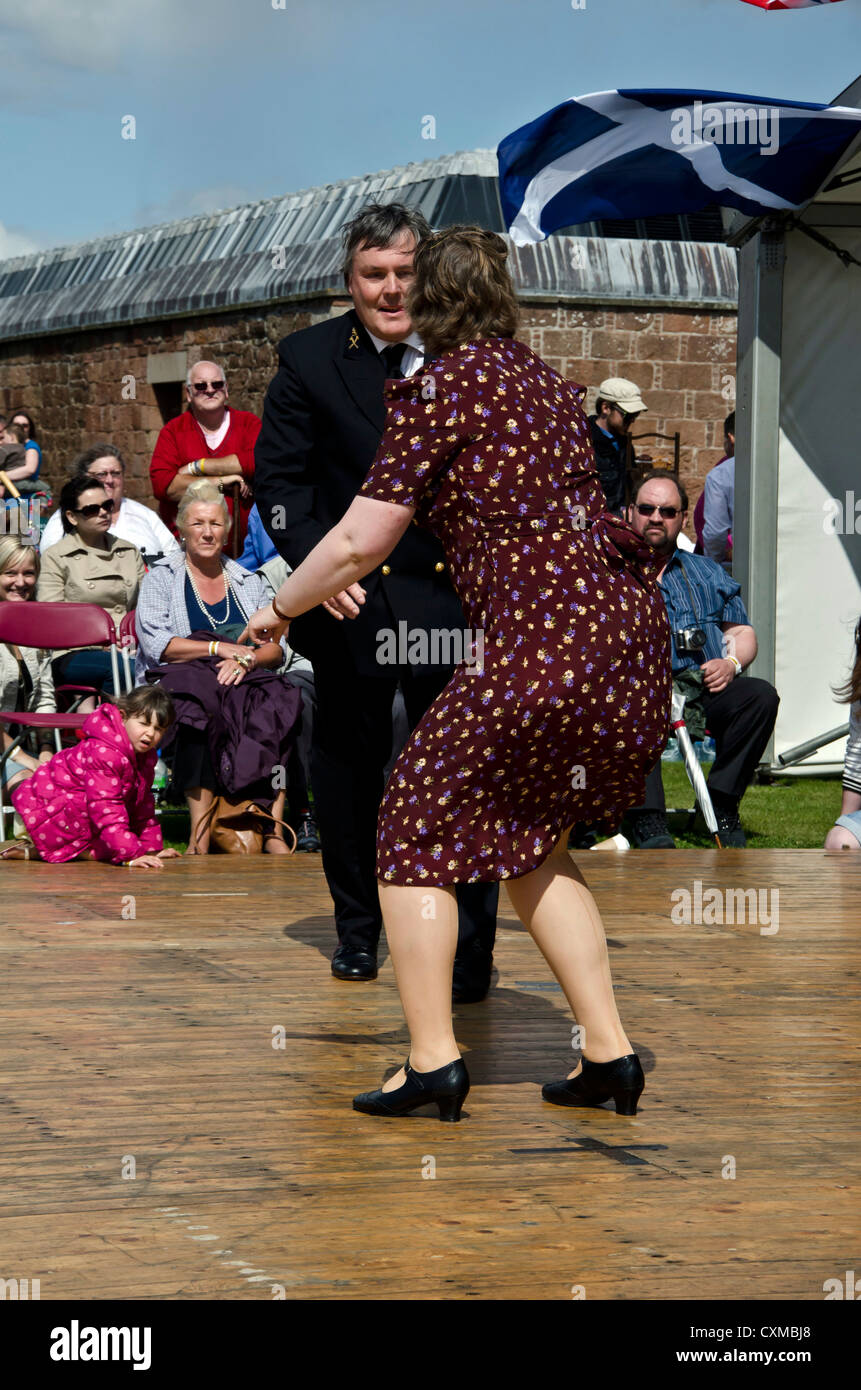 Couple in WW2 period clothes dancing the jitterbug at an historic event ...
