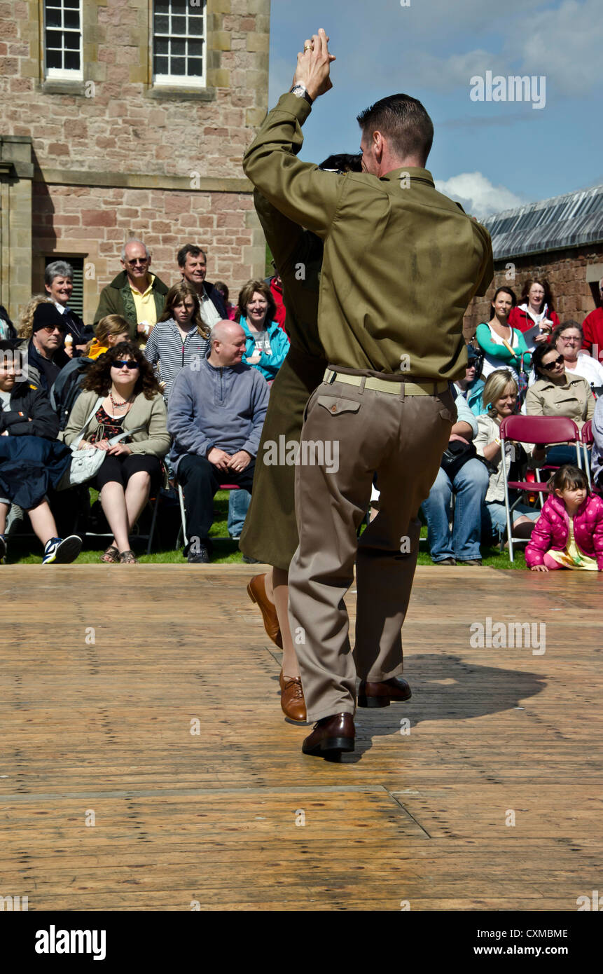 Couple in WW2 period clothes dancing the jitterbug at an historic event ...