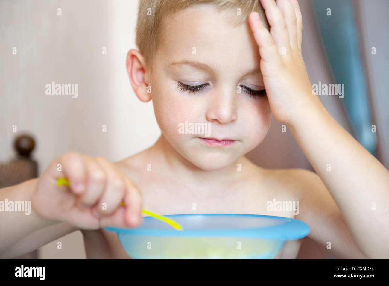 Little blond boy eating corn flakes with milk Stock Photo - Alamy