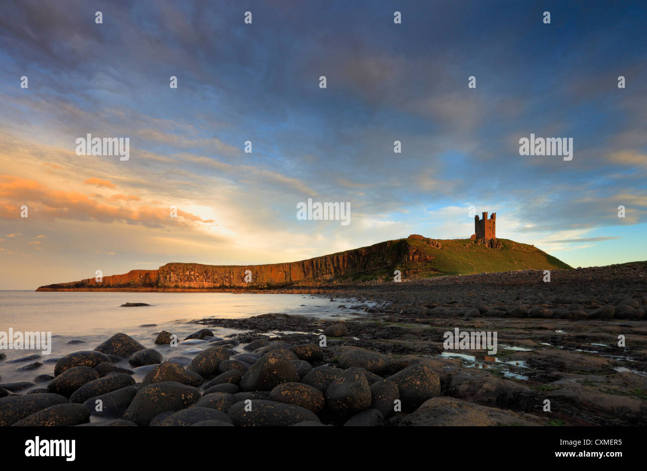 Dunstanburgh Castle at dusk Stock Photo - Alamy