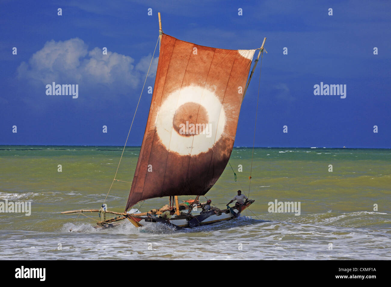 Traditional outrigger fishing boat sailing off the Negombo coastline in ...