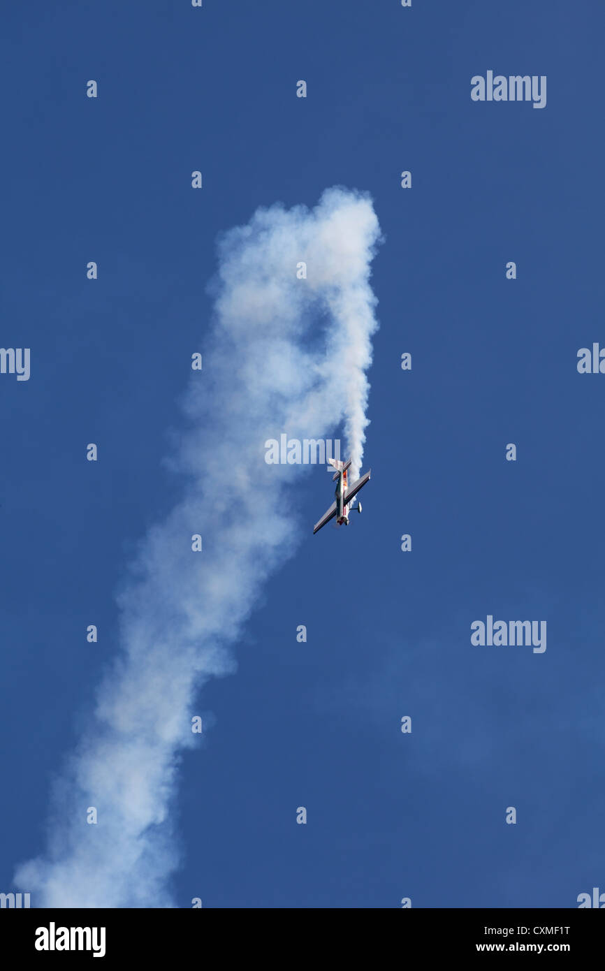 Extra EA230 G-XTRA carrying out aerobatic trailing smoke Stock Photo ...