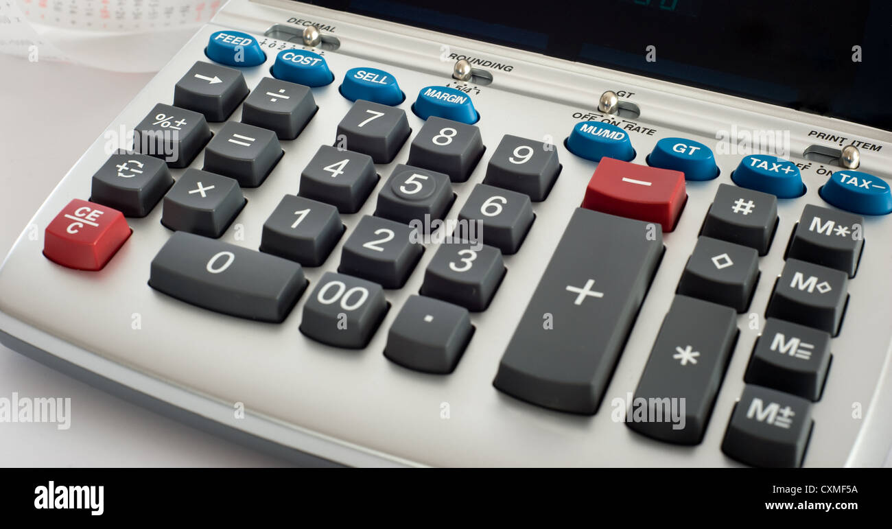 An adding machine or calculator with adding machine tape or paper Stock ...