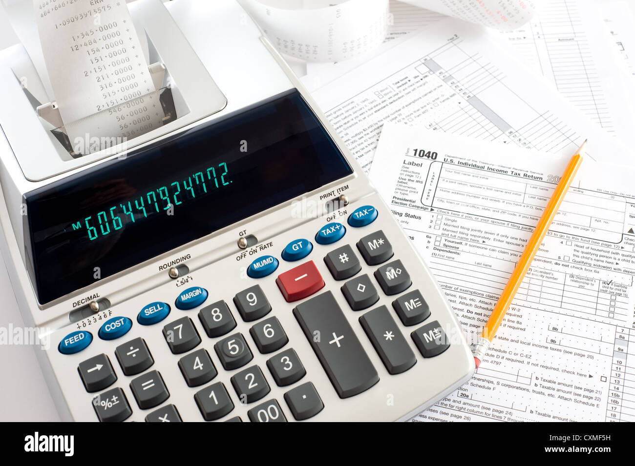 An adding machine or calculator with adding machine tape or paper and ...