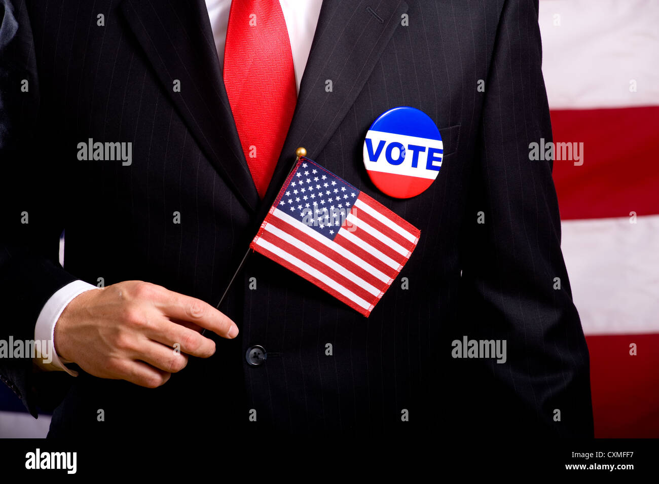 A man wearing a blue business suit and tie with a vote button and US ...