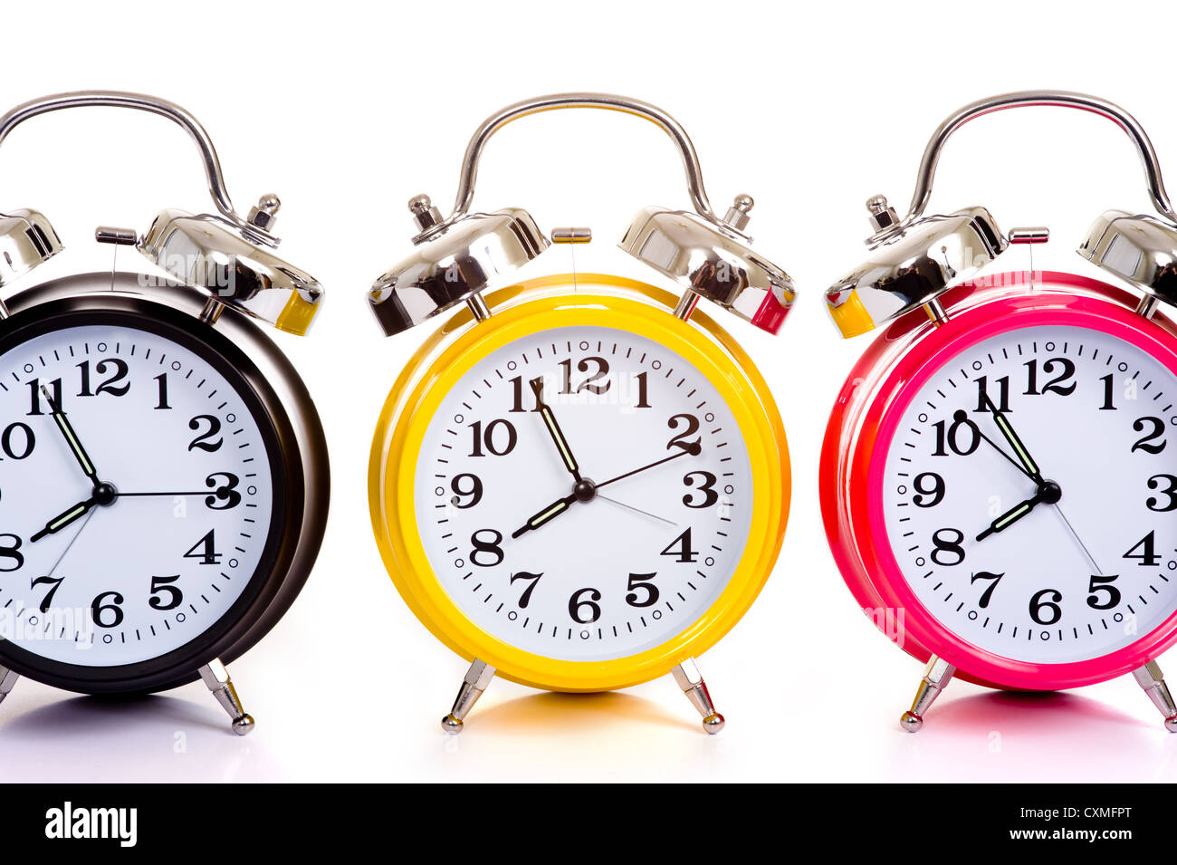 a group of multicolor clocks on a white background with copy space ...