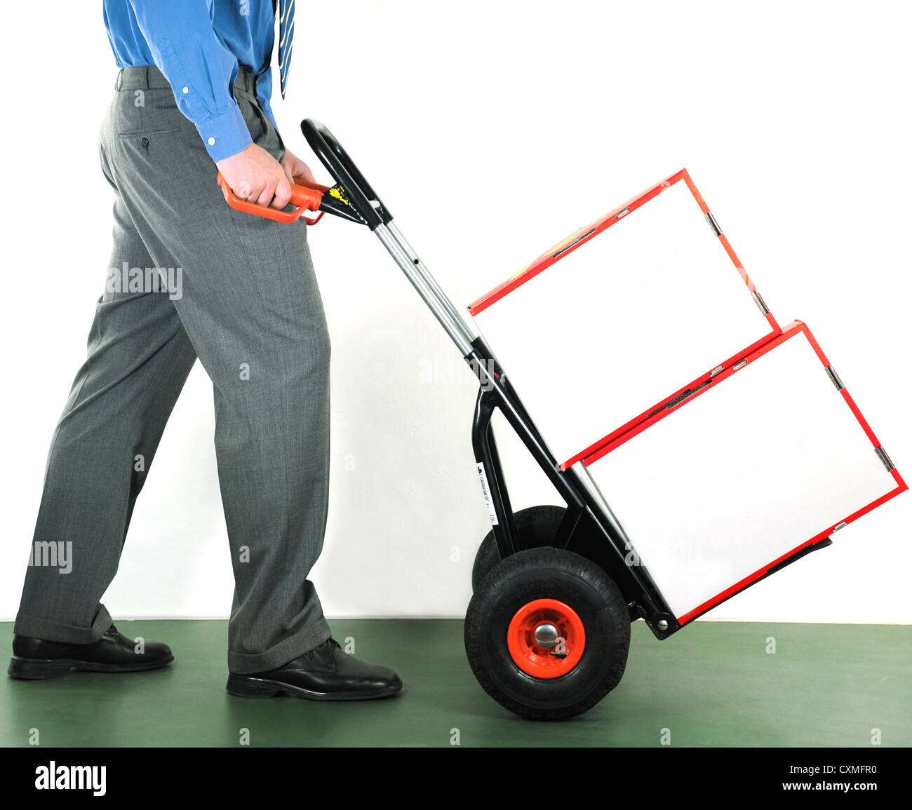 Businessman pushing a manual trolley. Two white blank boxes Stock Photo ...