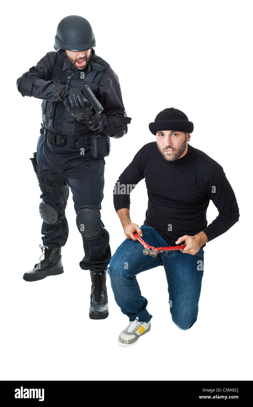 a scared burglar busted by a swat or police officer Stock Photo - Alamy