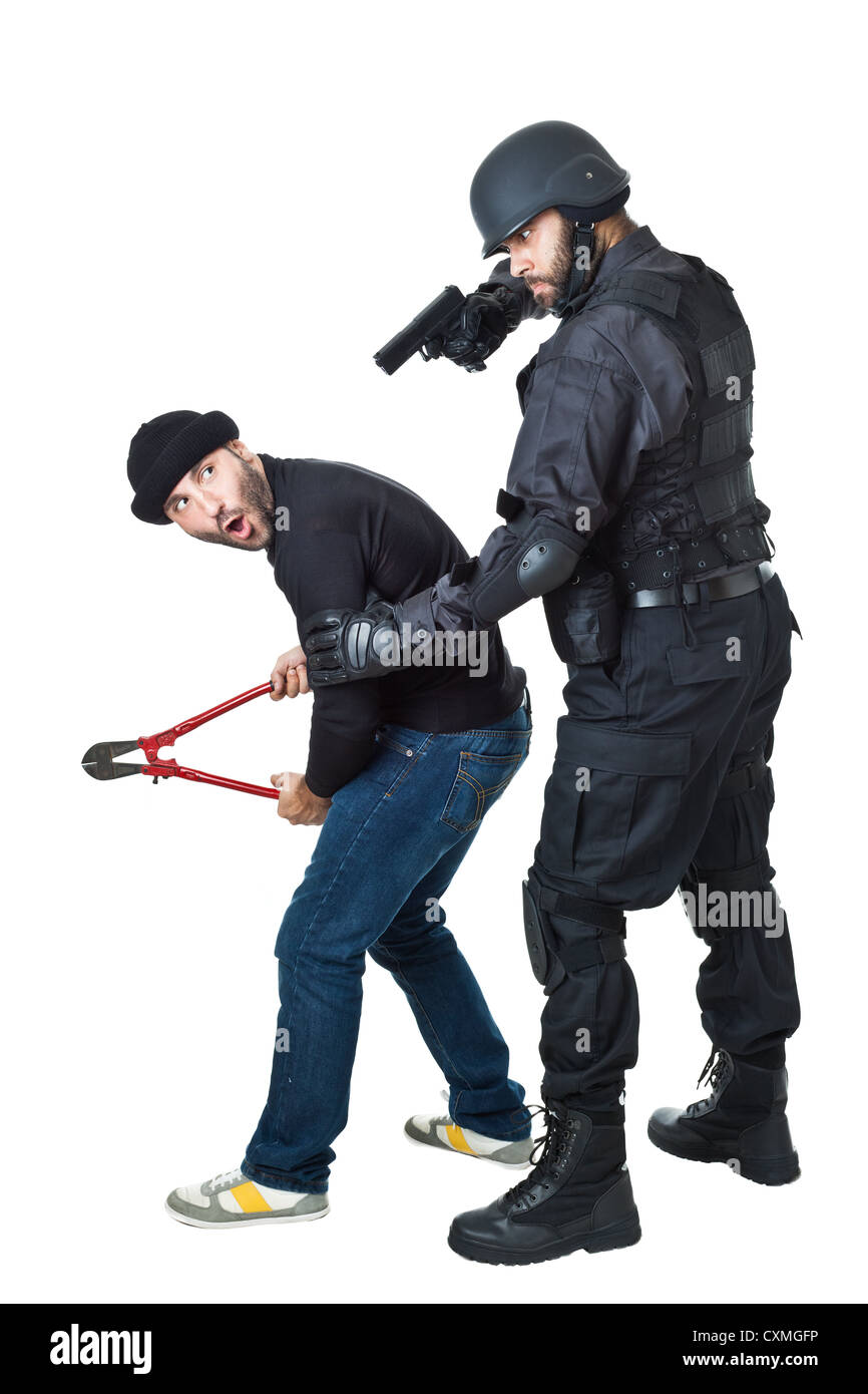 a scared burglar busted by a swat or police officer Stock Photo - Alamy