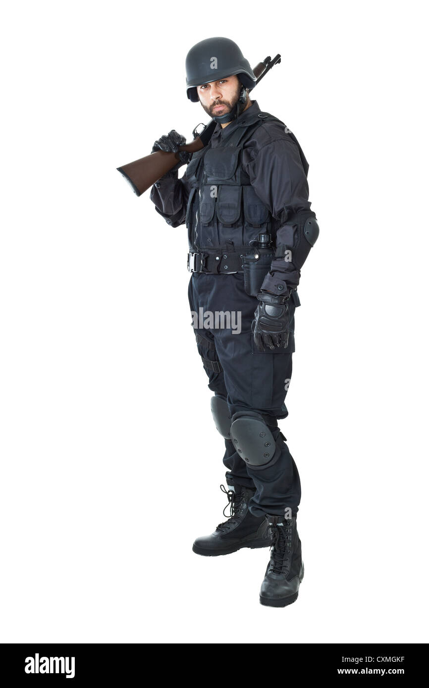 a swat agent wearing a bulletproof vest and aiming with a gun Stock ...