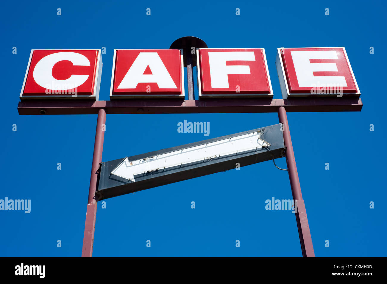 A red and white Café sign on a brightly blue sky background Stock Photo ...