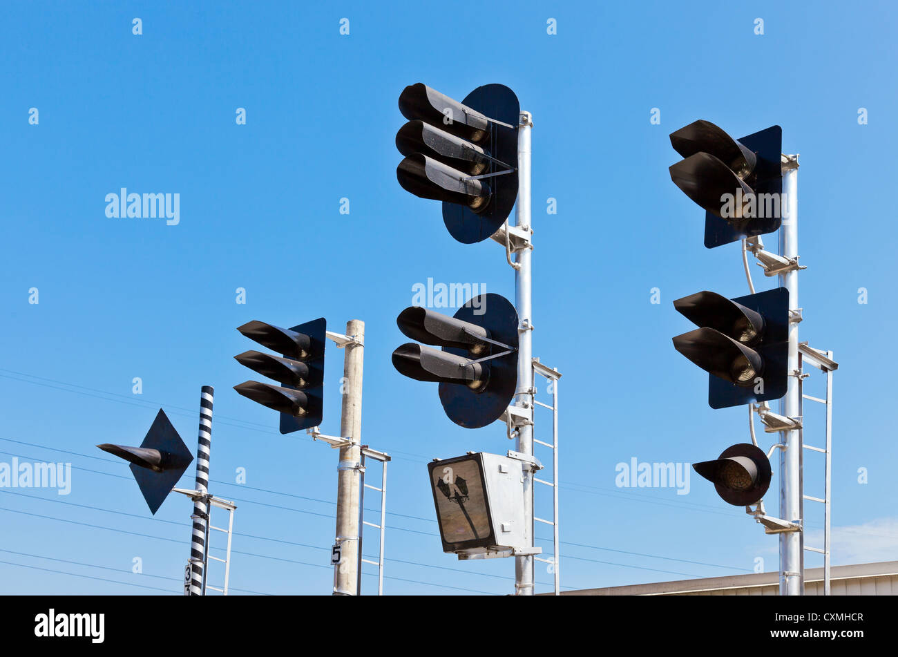 Railway Traffic Lights against blue sky background Stock Photo - Alamy