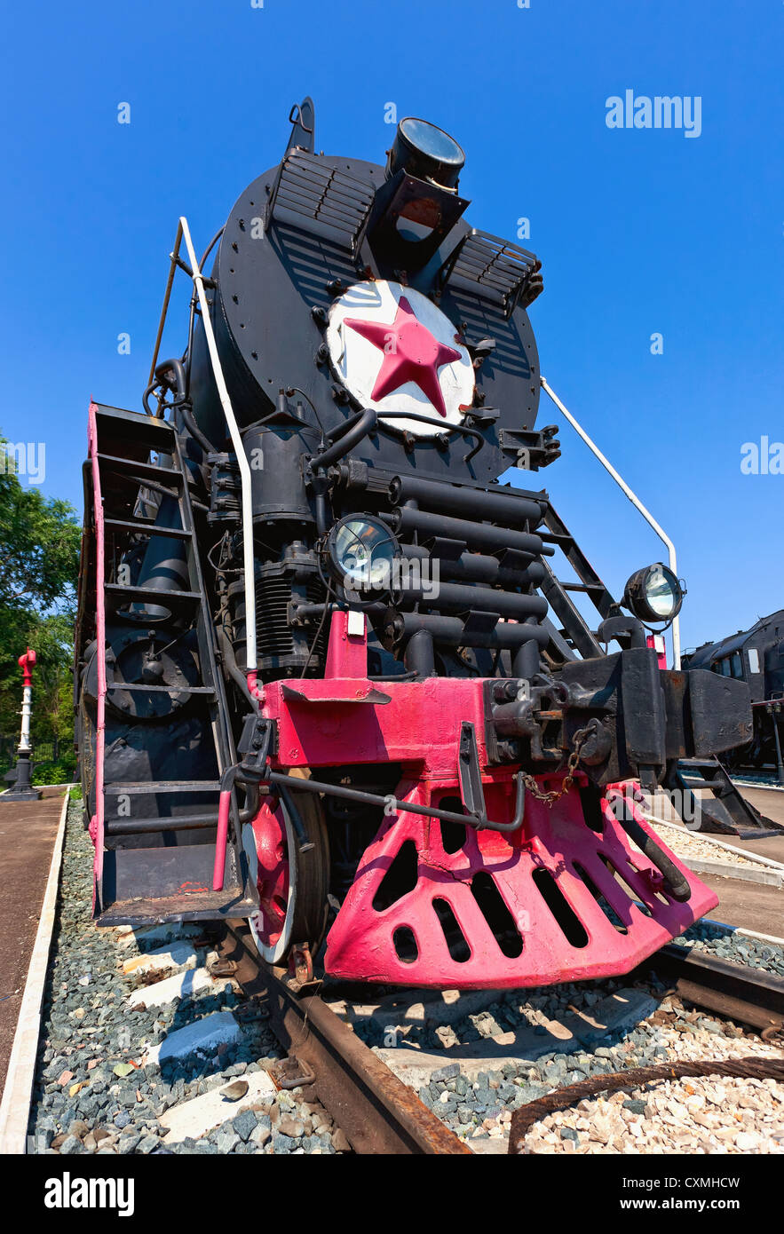 Old steam locomotive with red star against blue sky background Stock ...