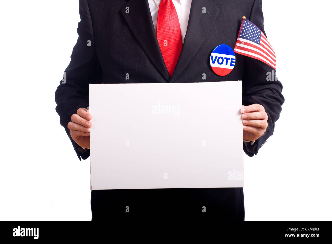 A man wearing a blue business suit and tie with a vote button and a ...