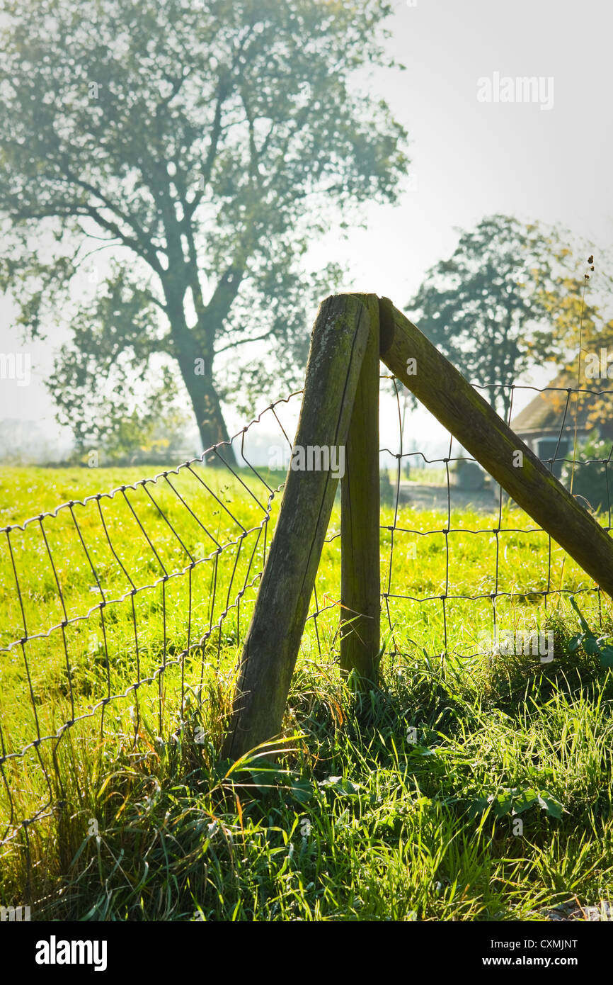 Fence on country field on hazy day in fall Stock Photo - Alamy