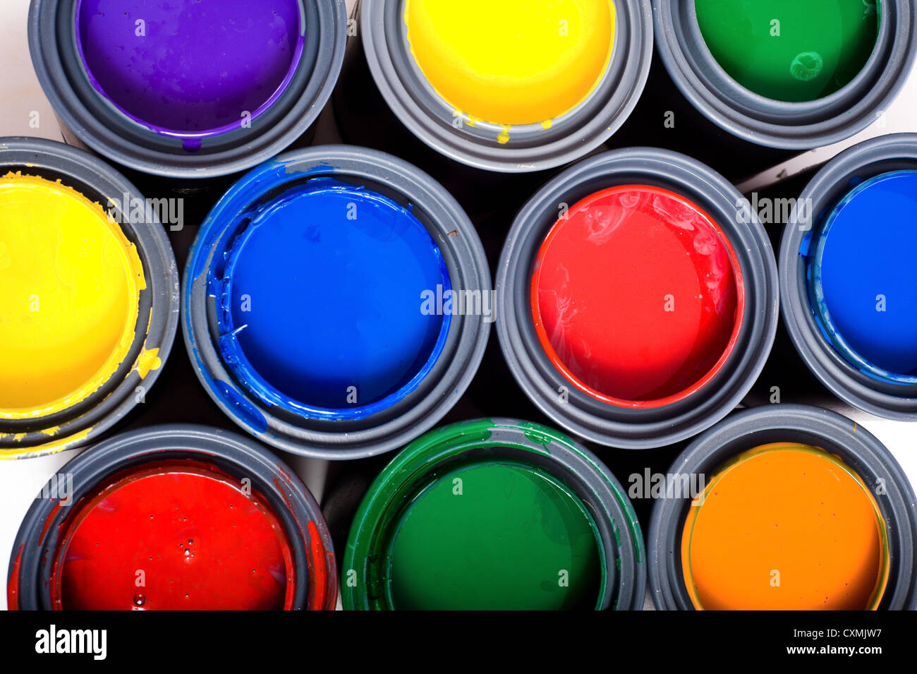Colorful cans of paint on a white background forming a colorful ...