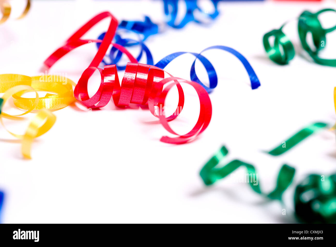 Colorful, curly, ribbon streamers on a white background with copy space ...