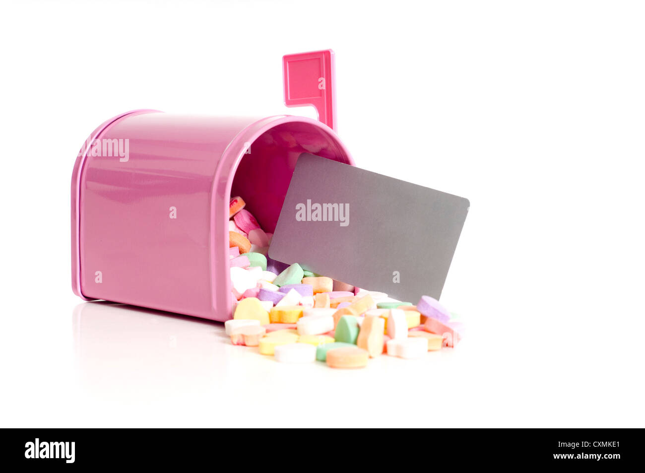 A pink mail box with conversation hearts and a blank notecard falling ...