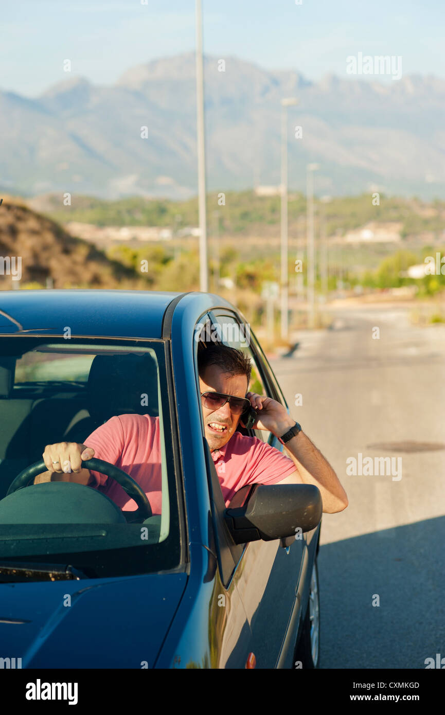 Aggressive guy yelling on the phone while driving Stock Photo - Alamy