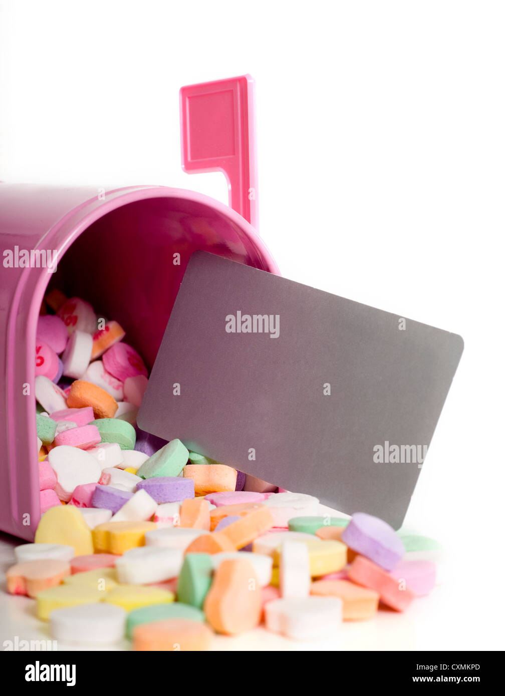 A pink mail box with conversation hearts and a blank notecard falling ...