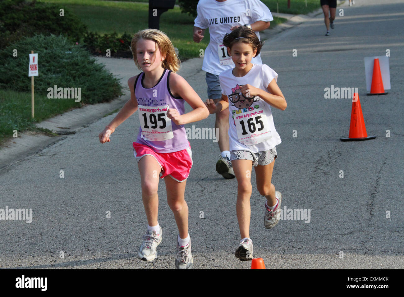 Two young girls race in the 5K Run Walk Stock Photo - Alamy