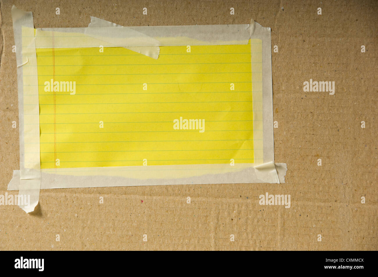 Blank note taped to cardboard box - insert your own text or graphics ...
