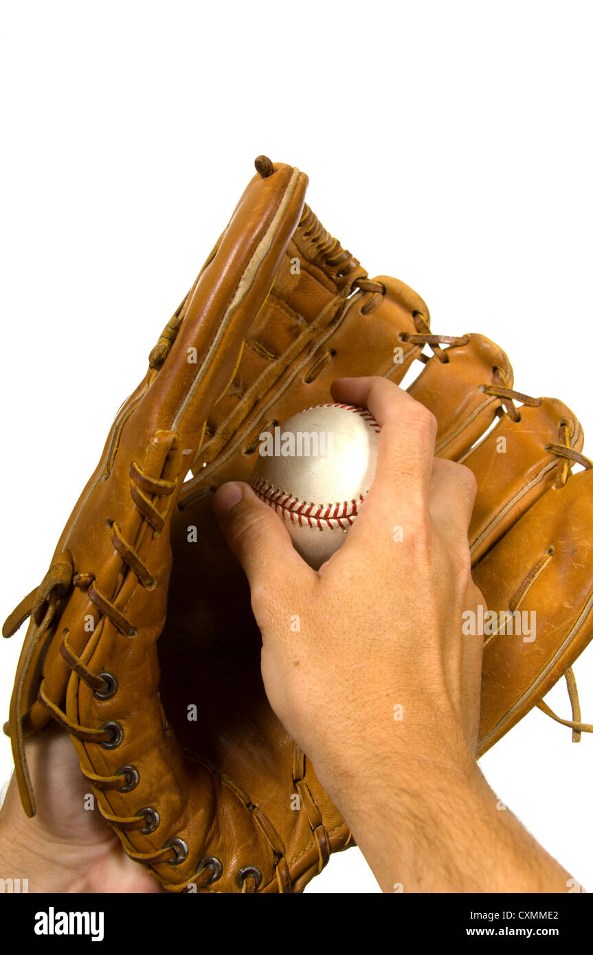 Pitcher holding baseball in glove against white background Stock Photo ...